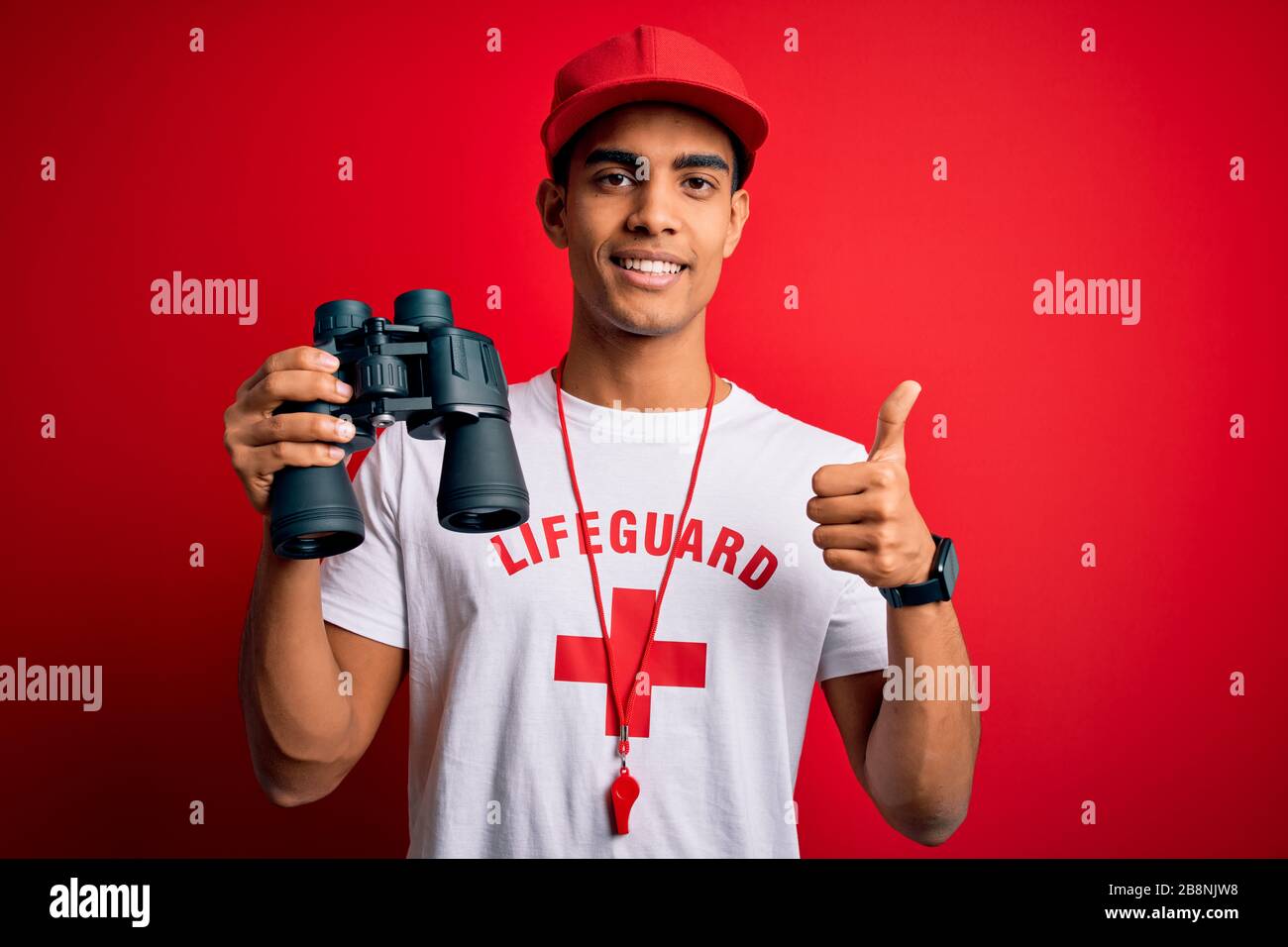 Young handsome african american lifeguard man wearing whistle using ...