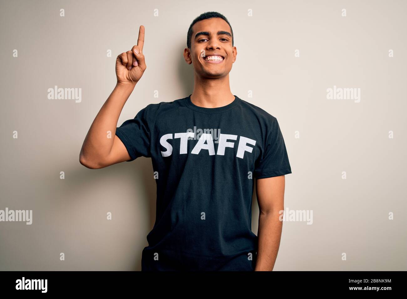 Young handsome african american worker man wearing staff uniform over ...