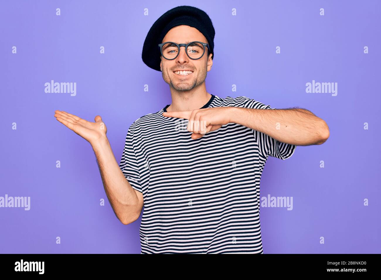 Handsome man with blue eyes wearing striped t-shirt and french beret ...