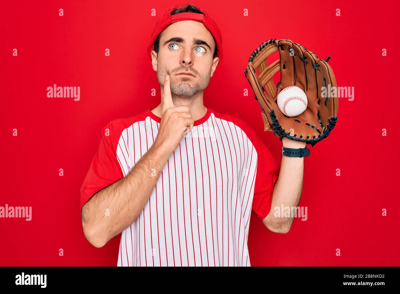 Young handsome sporty man with blue eyes playing baseball using glove ...