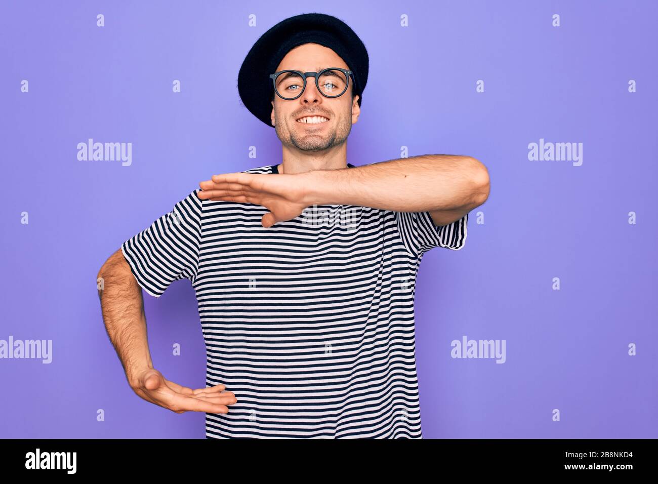 Handsome man with blue eyes wearing striped t-shirt and french beret ...