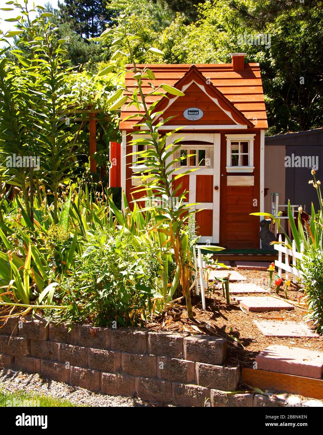 Garden scene with children's playhouse Stock Photo - Alamy
