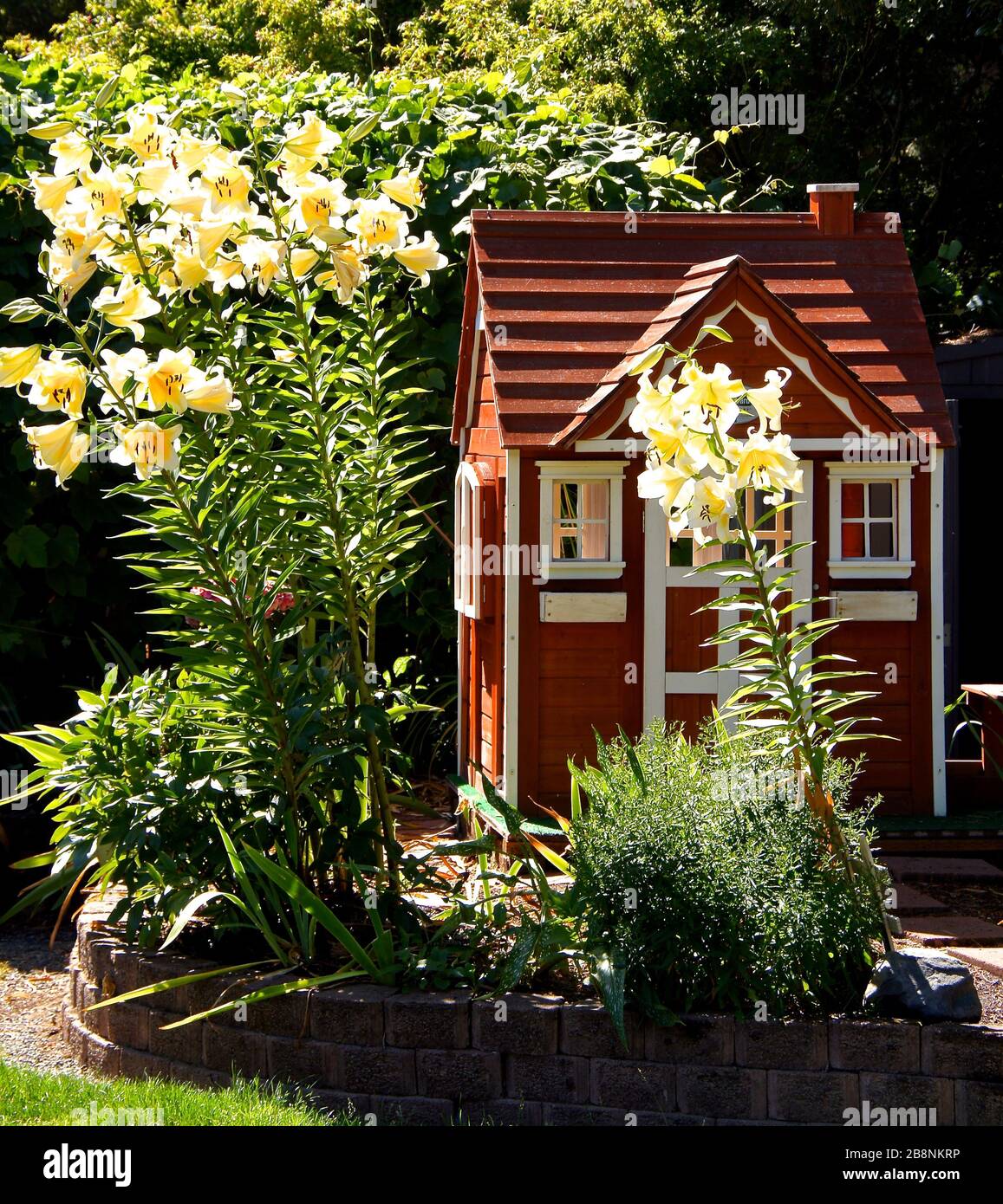 Garden scene with children's playhouse Stock Photo - Alamy