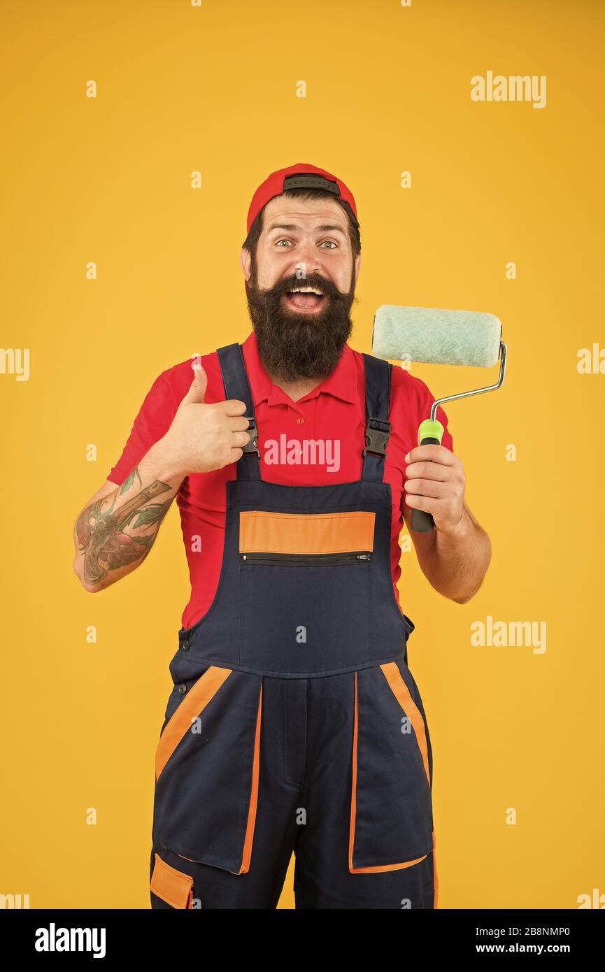 well done. repair success. bearded man worker with roller tool. hipster ...
