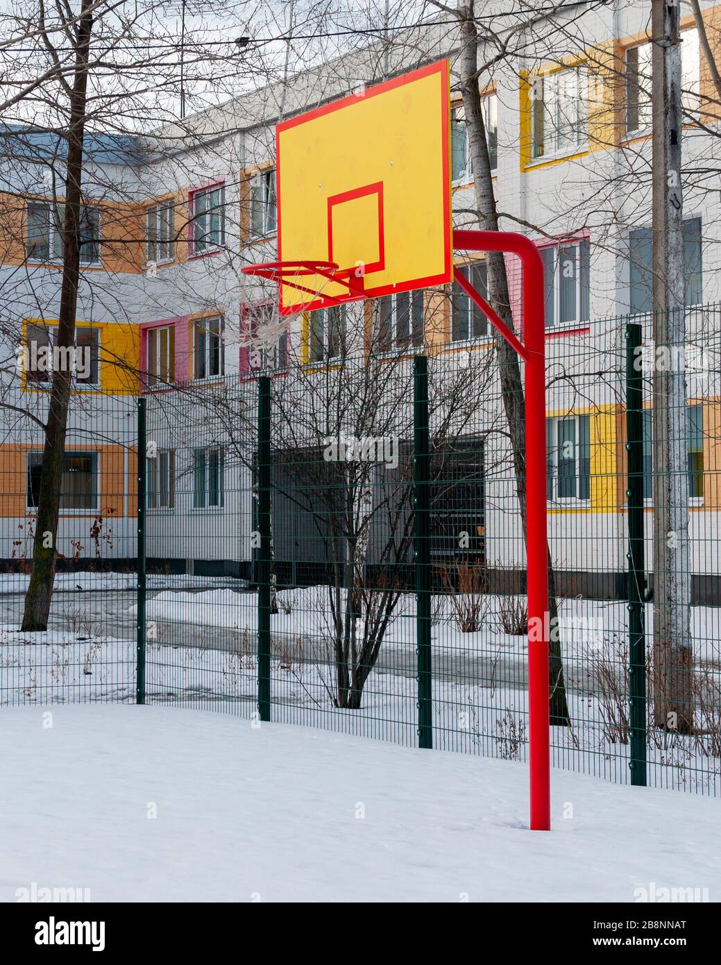 Snow-covered basketball court in the school yard Stock Photo - Alamy