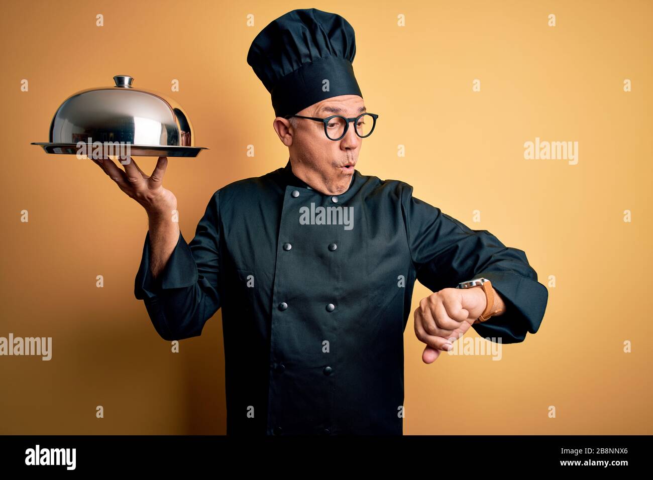 Middle age handsome grey-haired waiter man wearing cooker uniform and ...