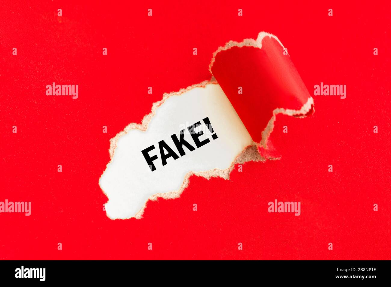 Torn red paper with word fake on white background. Fake news concept ...