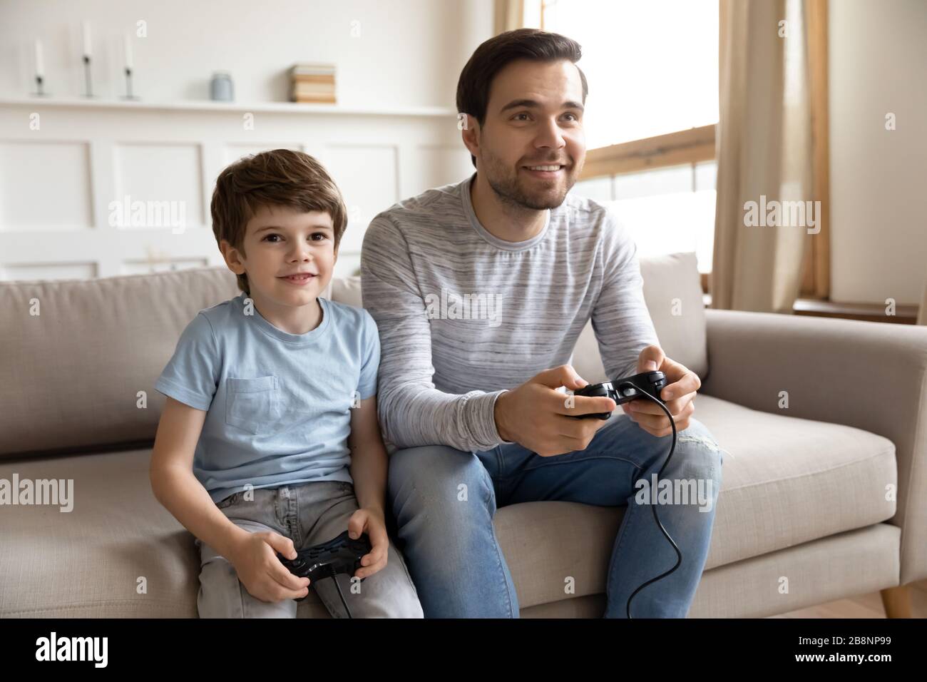 Happy dad and preschooler son play computer games together Stock Photo ...