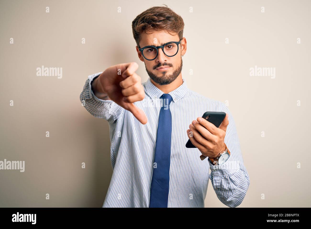 Young businessman having a conversation using smartphone over white ...