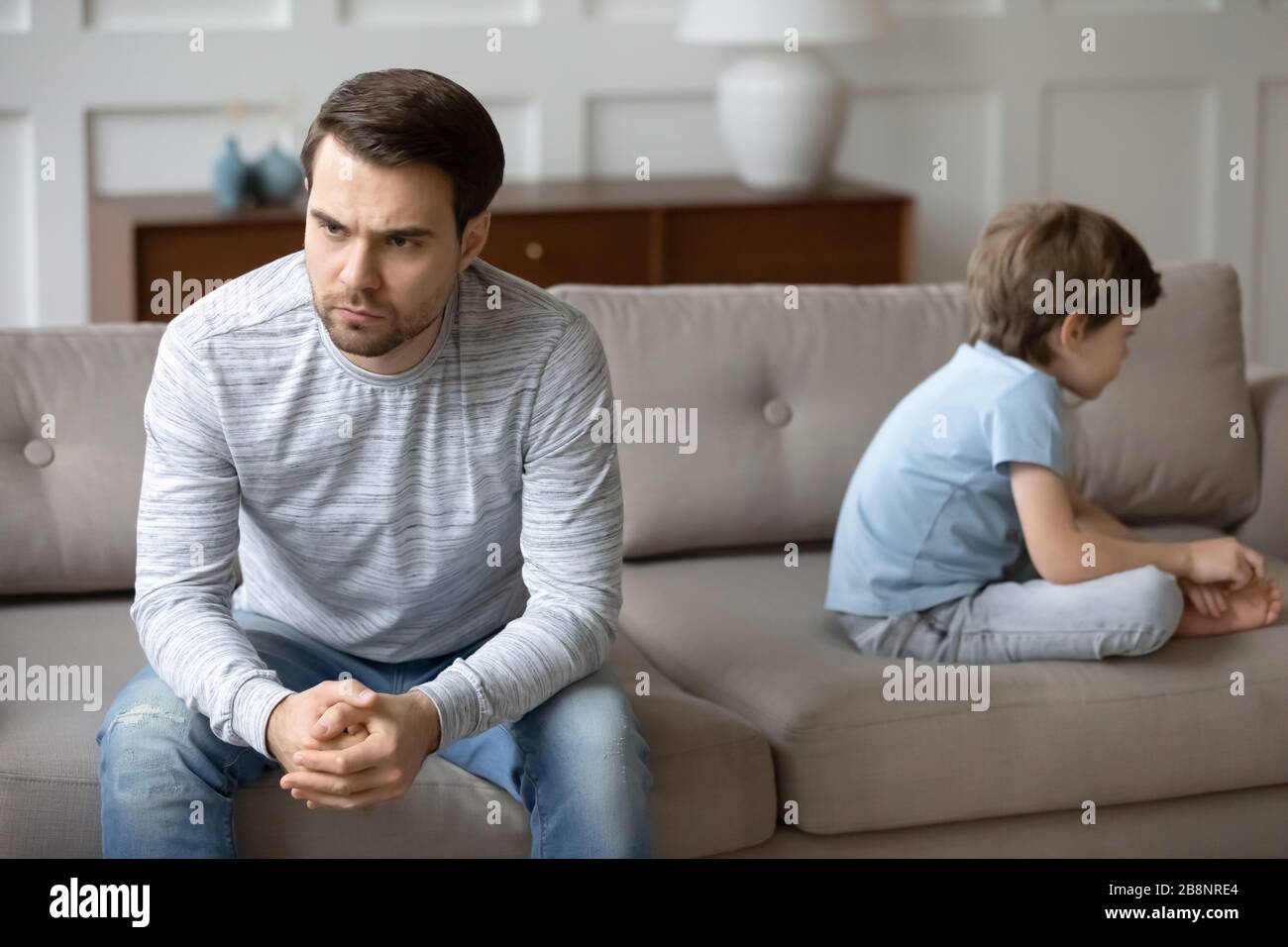 Angry young dad and little son have family fight Stock Photo - Alamy