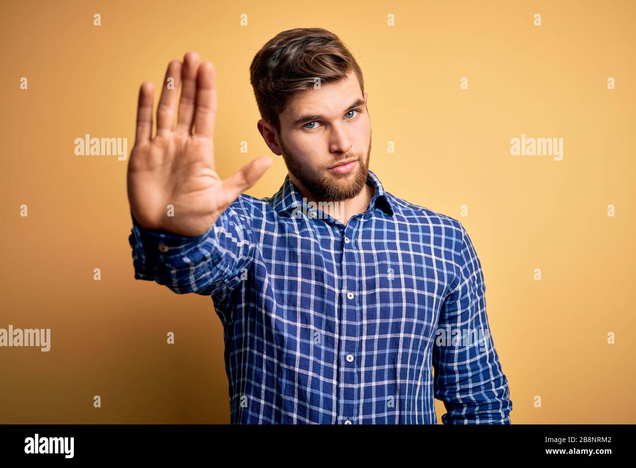 Young blond businessman with beard and blue eyes wearing shirt over ...