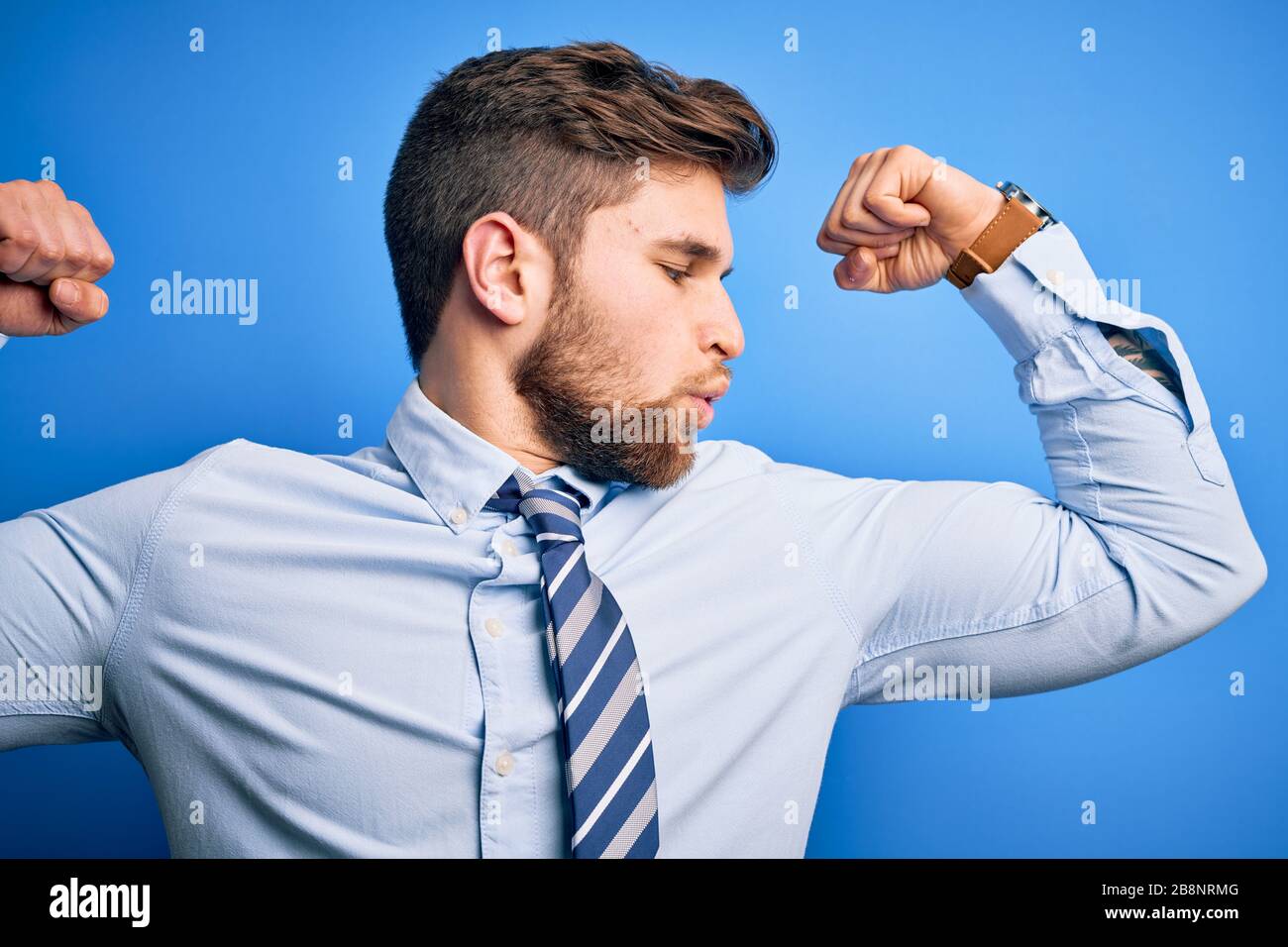 Young blond businessman with beard and blue eyes wearing elegant shirt ...