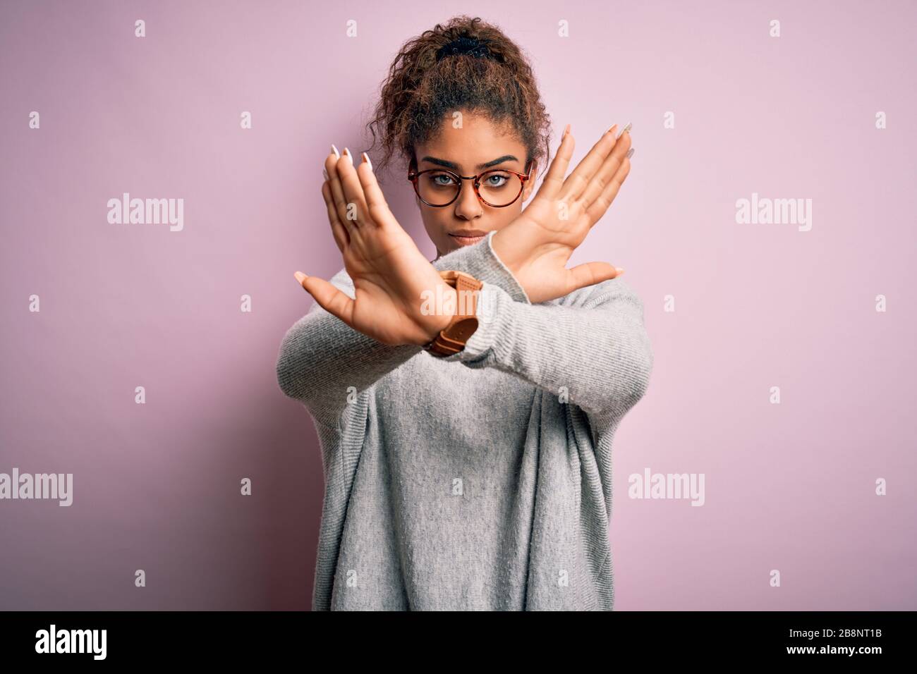 Young beautiful african american girl wearing sweater and glasses over ...