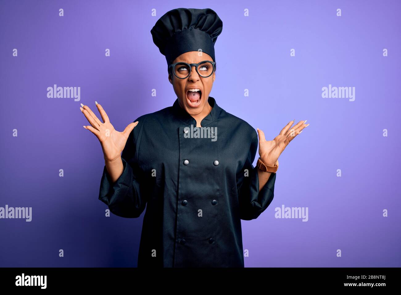 Young african american chef girl wearing cooker uniform and hat over ...