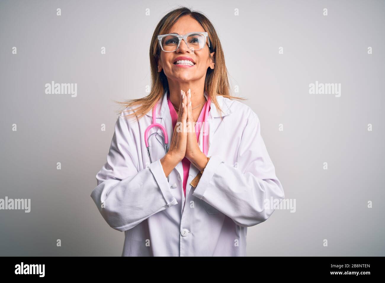 Middle age beautiful doctor woman wearing pink stethoscope over ...