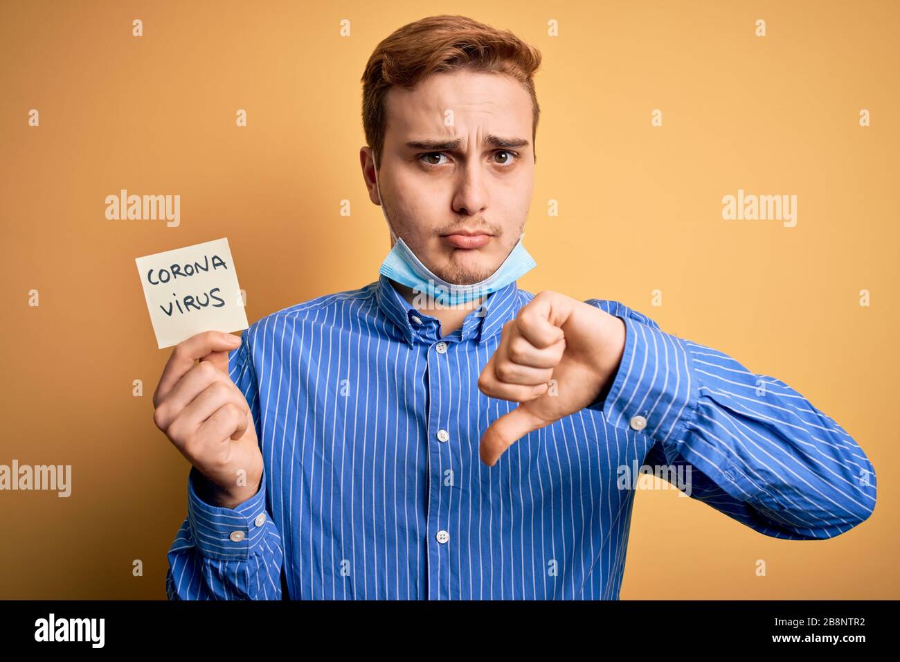Young man wearing medical security mas holding paper note reminder with ...