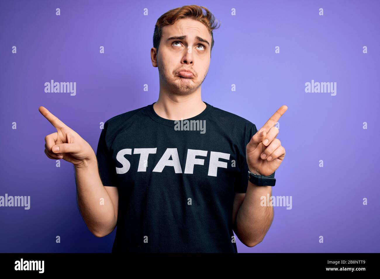 Young handsome redhead worker man wearing staff t-shirt uniform over ...
