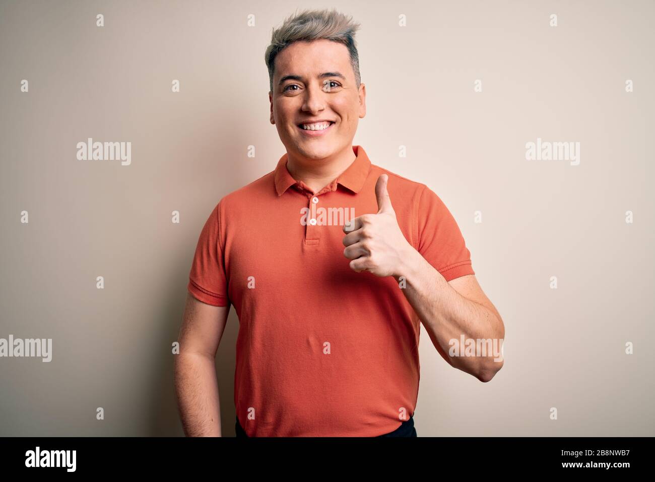Young handsome modern man standing over isolated background doing happy ...
