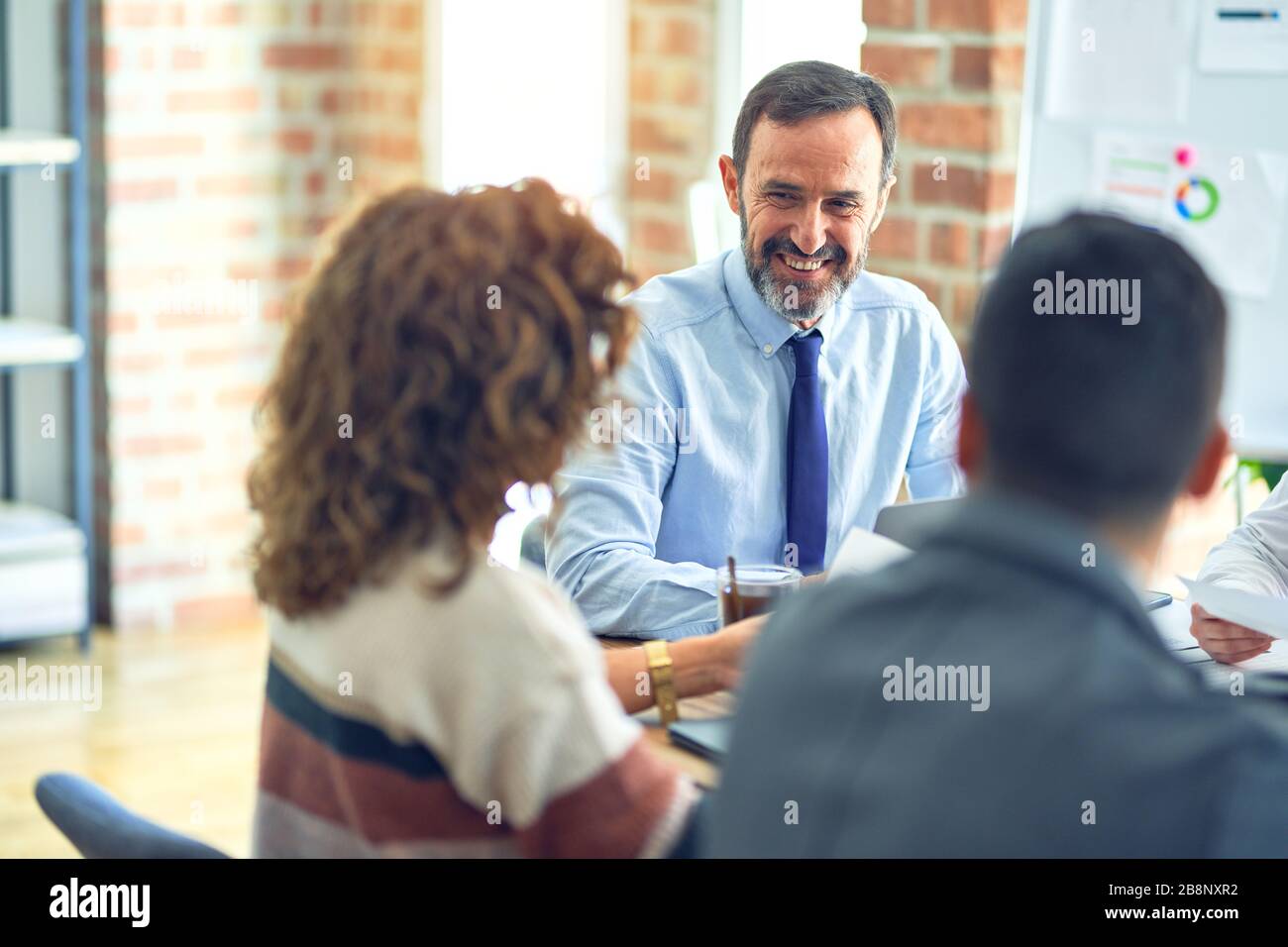 Group of business workers smiling happy working together. Sitting on ...