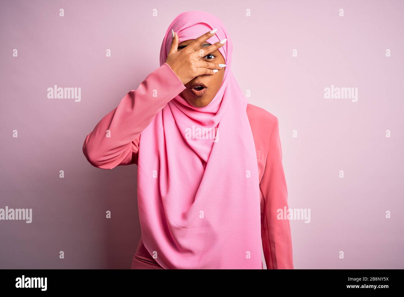 Young African American afro woman wearing muslim hijab over isolated ...