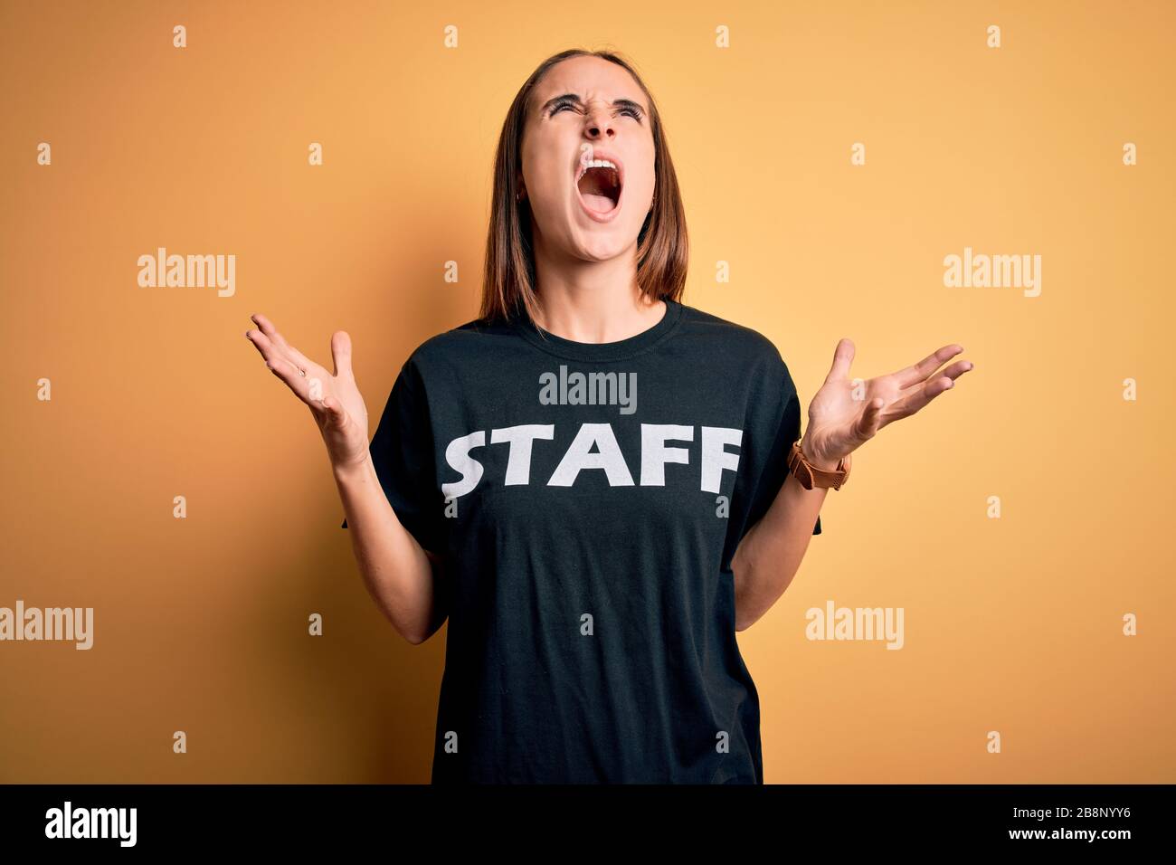 Young beautiful worker woman wearing staff uniform t-shirt over ...