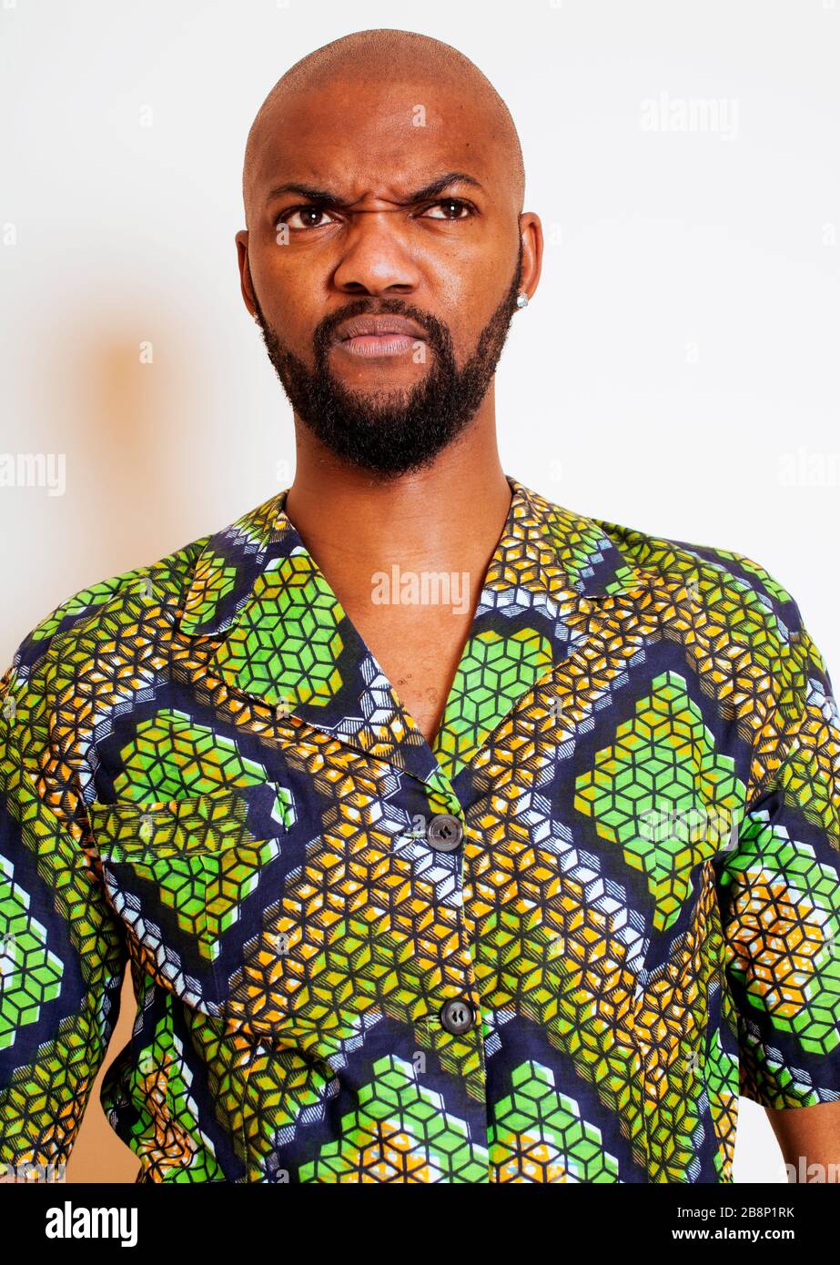 portrait of young handsome african man wearing bright green national ...