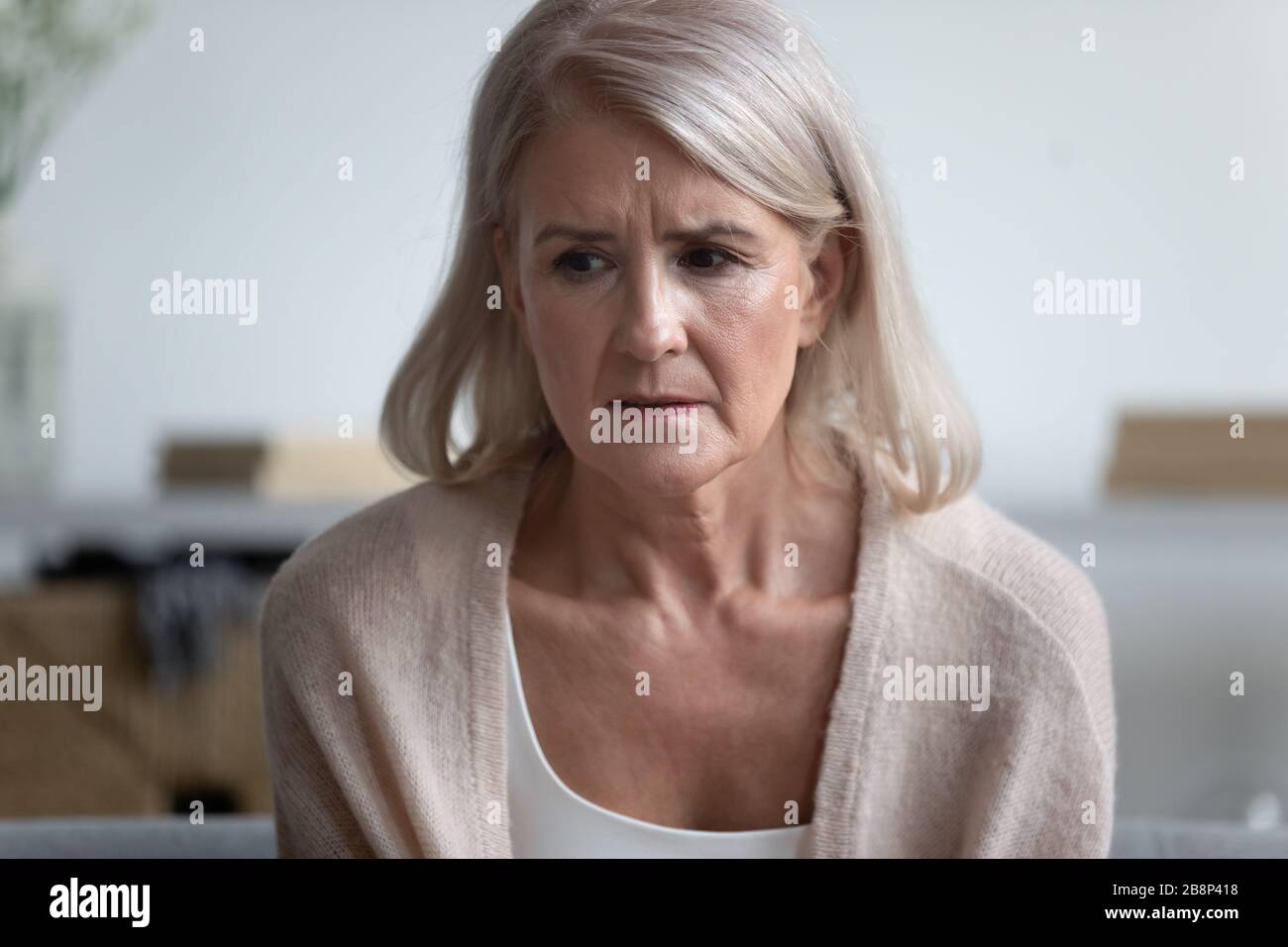 Frustrated worrying middle aged sad woman having health problem Stock ...