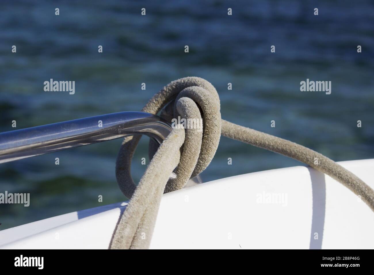 mooring rope tied by a sea knot on the railing of the boat. reportage ...