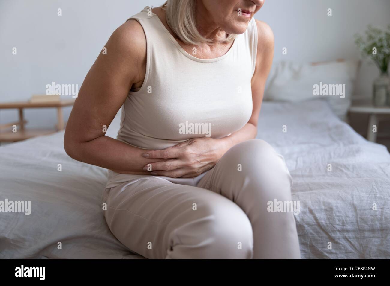 Unhealthy woman embracing belly, suffering from strong stomach ache ...