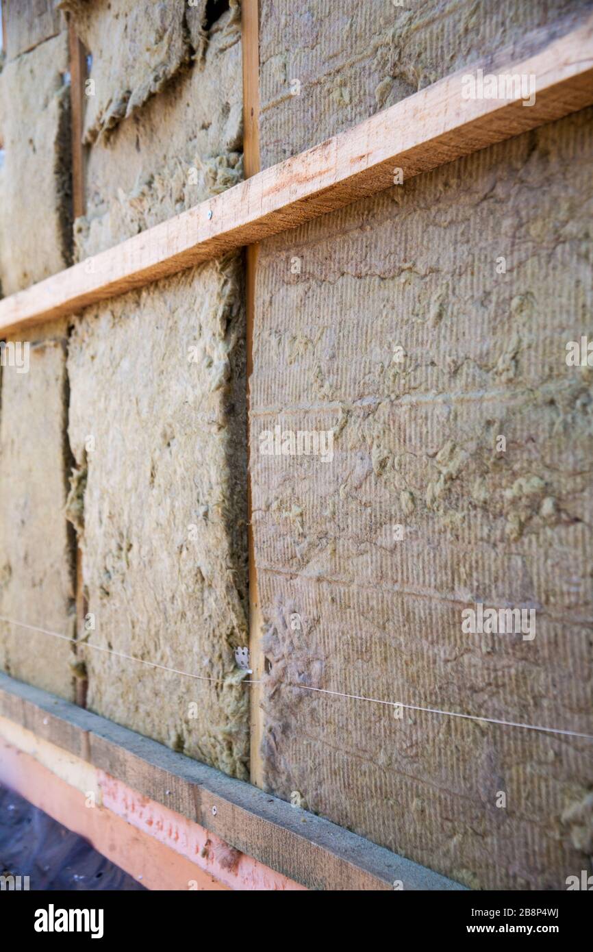 warming the walls of a stone house with a stone wool heater. Ecological ...