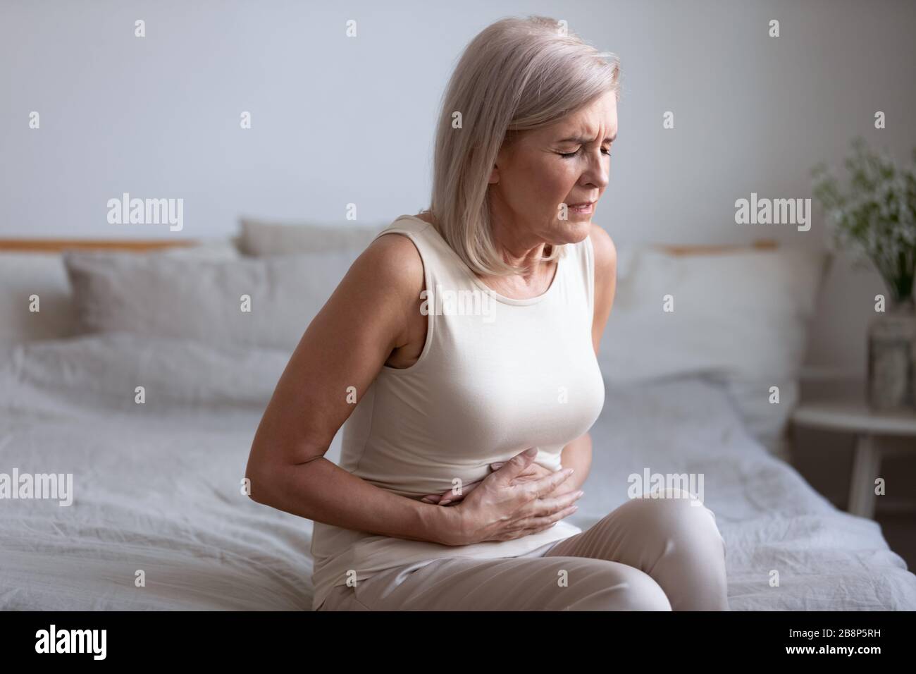 Unhealthy middle aged woman suffering from strong stomach ache Stock ...