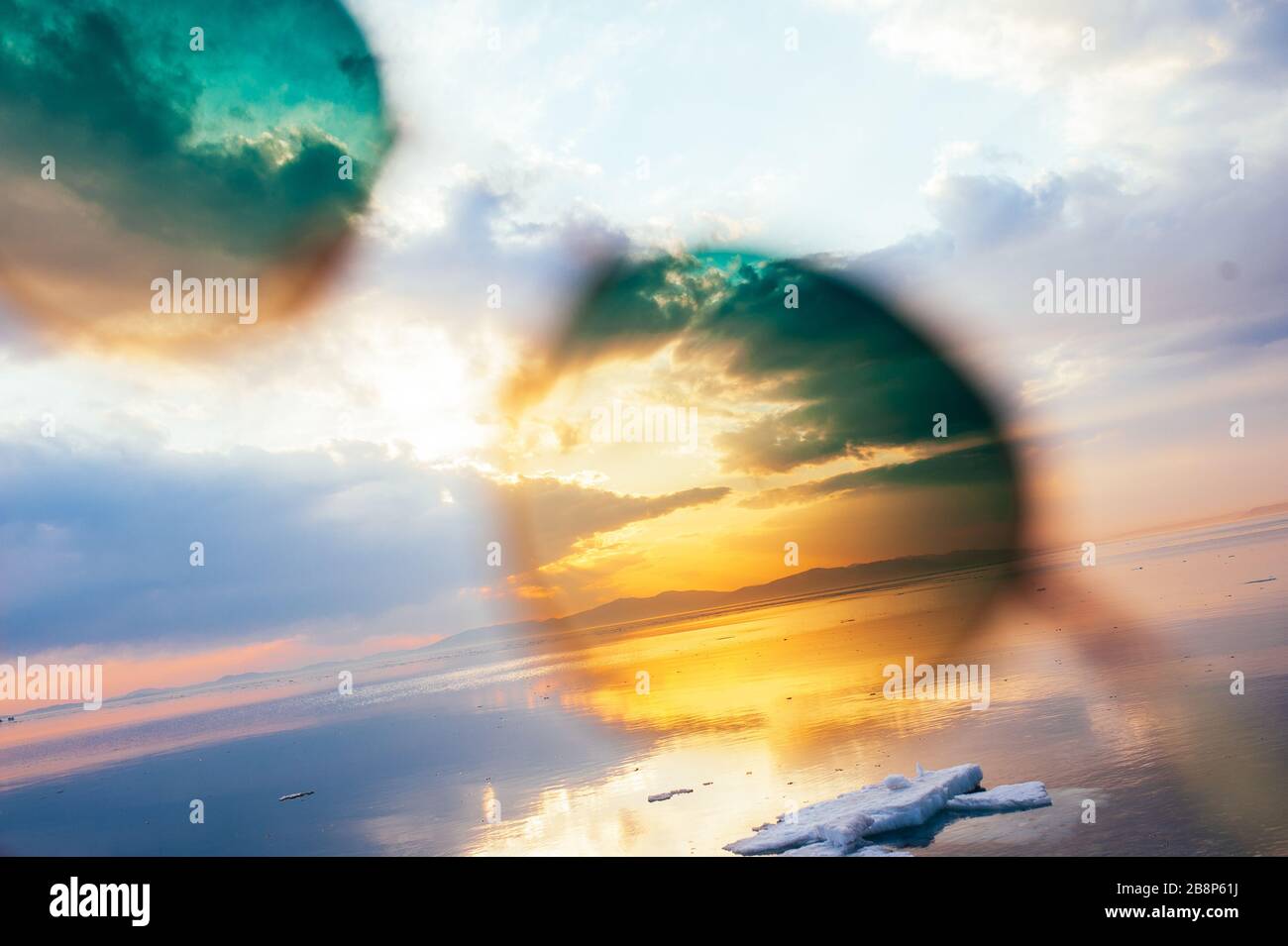 Unusual and bright colorful image of the sunset through sunglasses ...