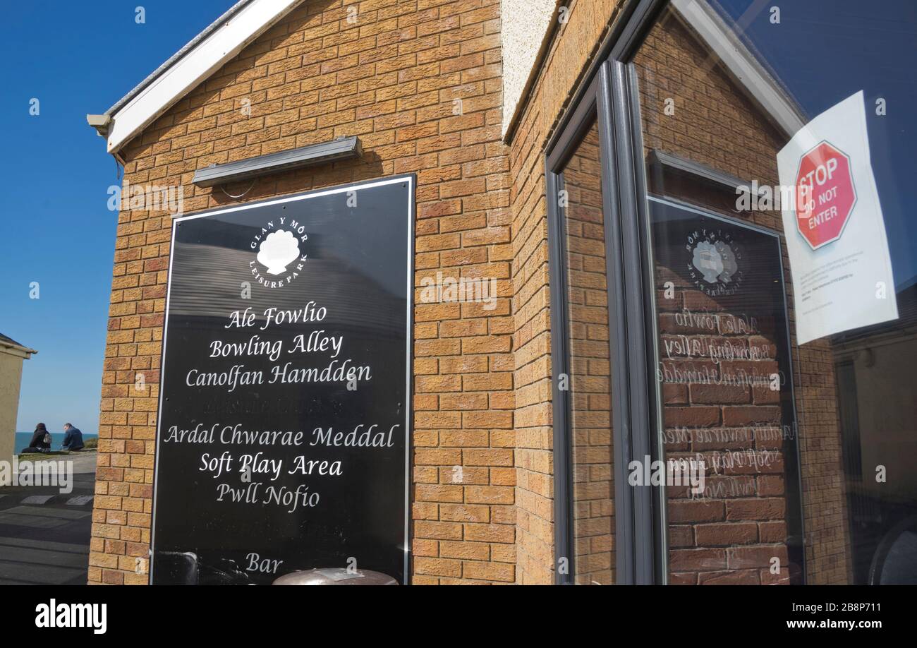 Couple by the seaside in in closed down caravan park with bilingual ...