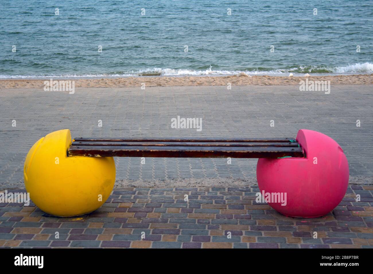 seaside bench with colorful support Stock Photo - Alamy