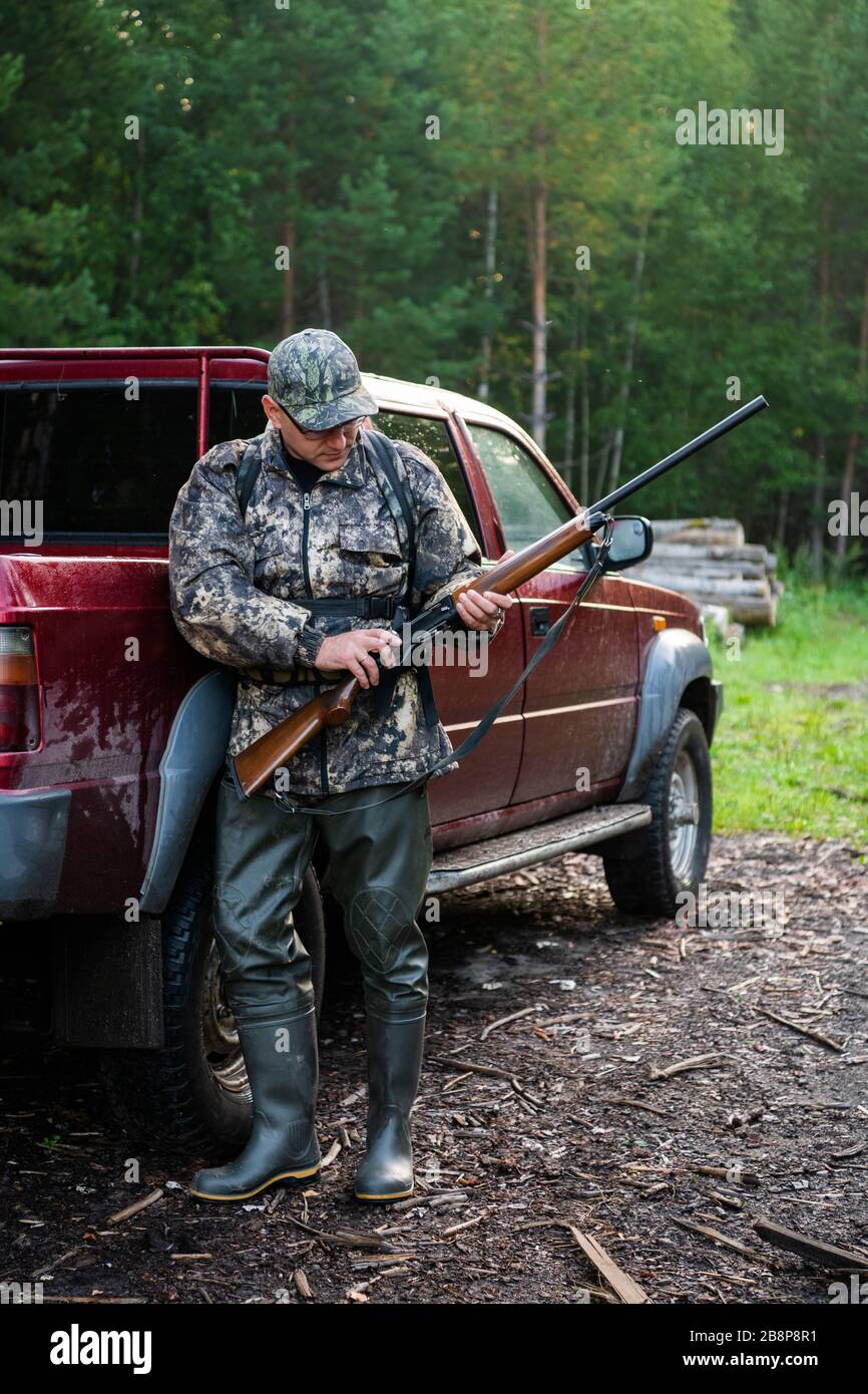 Hunter male loading gun, wearing casual hunting clothes, stock and ...