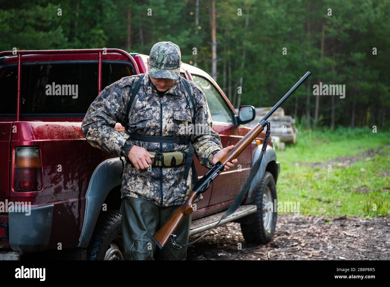 Hunter male loading gun, wearing casual hunting clothes, stock and ...