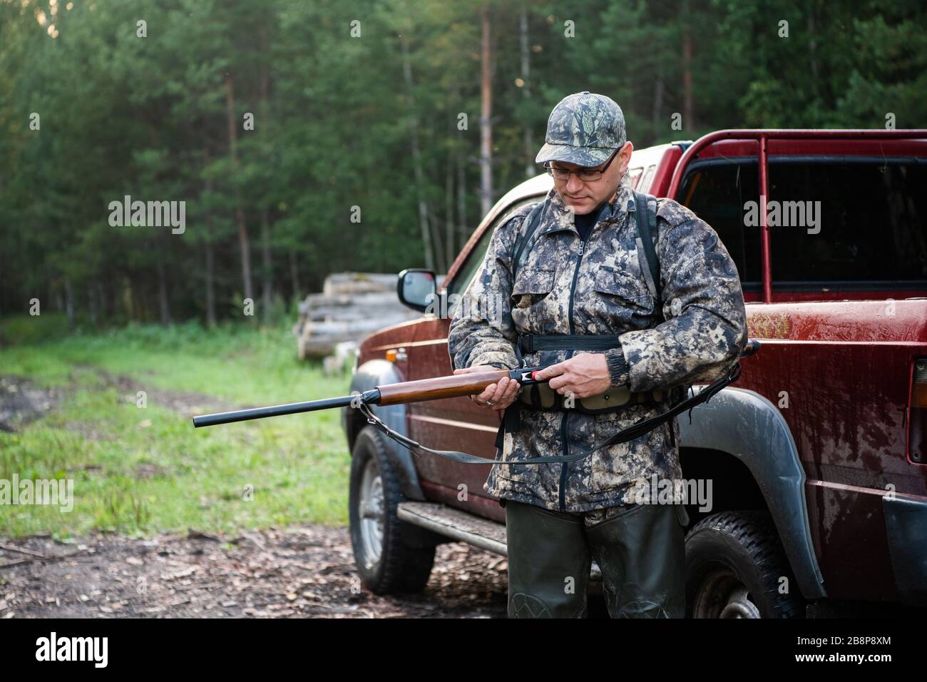 Hunter male loading gun, wearing casual hunting clothes, stock and ...