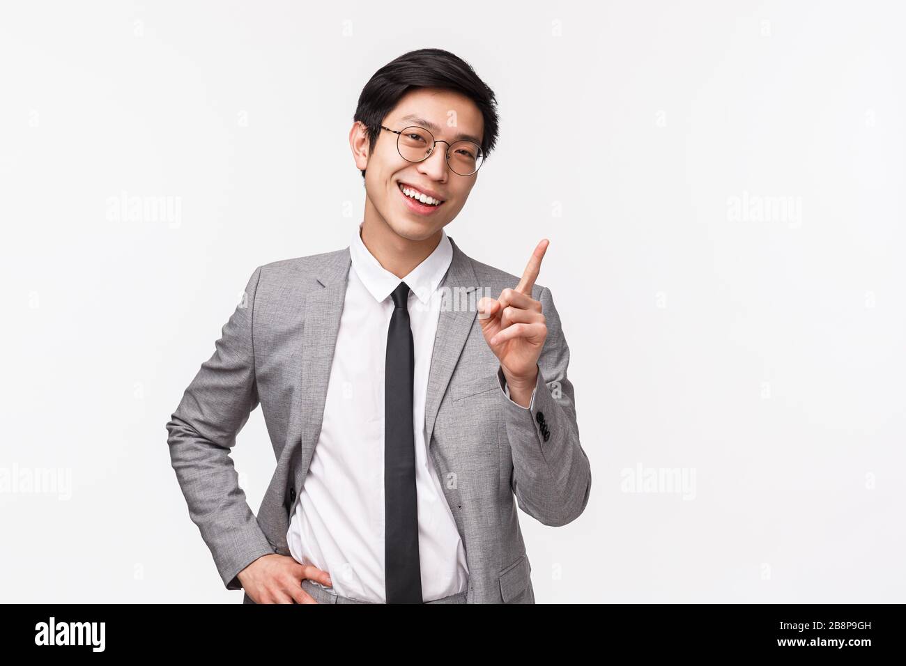 Good point. Waist-up portrait of impressed handsome asian businessman ...