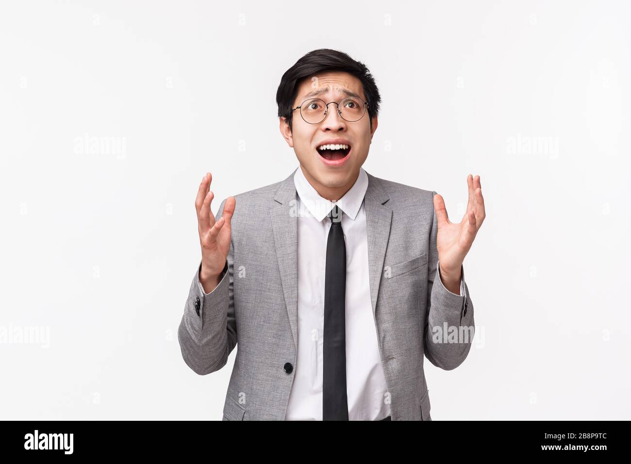 Desperate young man pleading with hands hi-res stock photography and ...