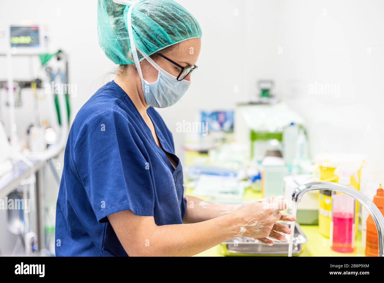 Coronavirus prevention. Nurse washing her hands after treat a patient ...