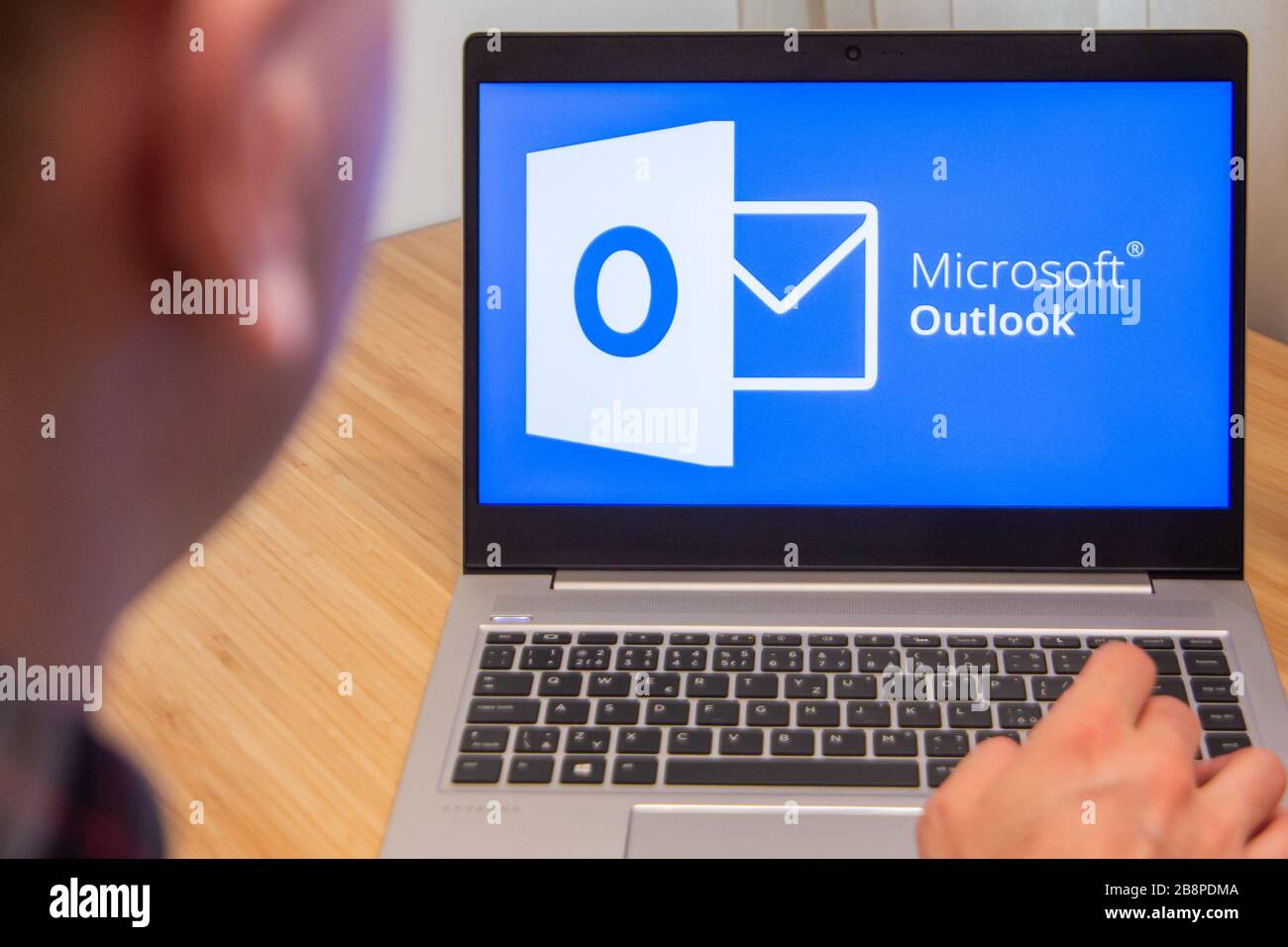 Outlook is used by a man on the laptop. Microsoft customer used ...