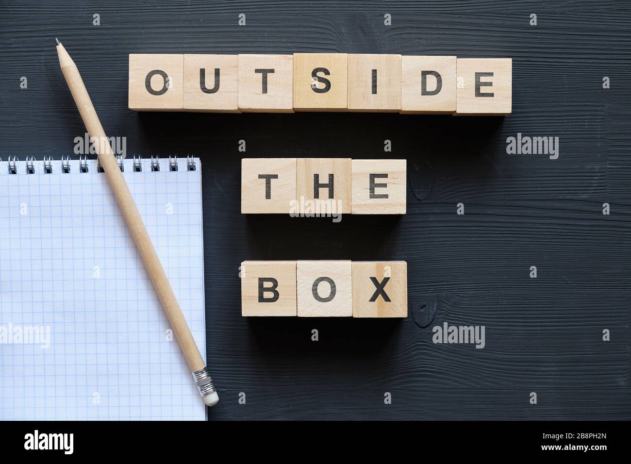 Modern business buzzword - Outside the Box. Top view on a black board ...