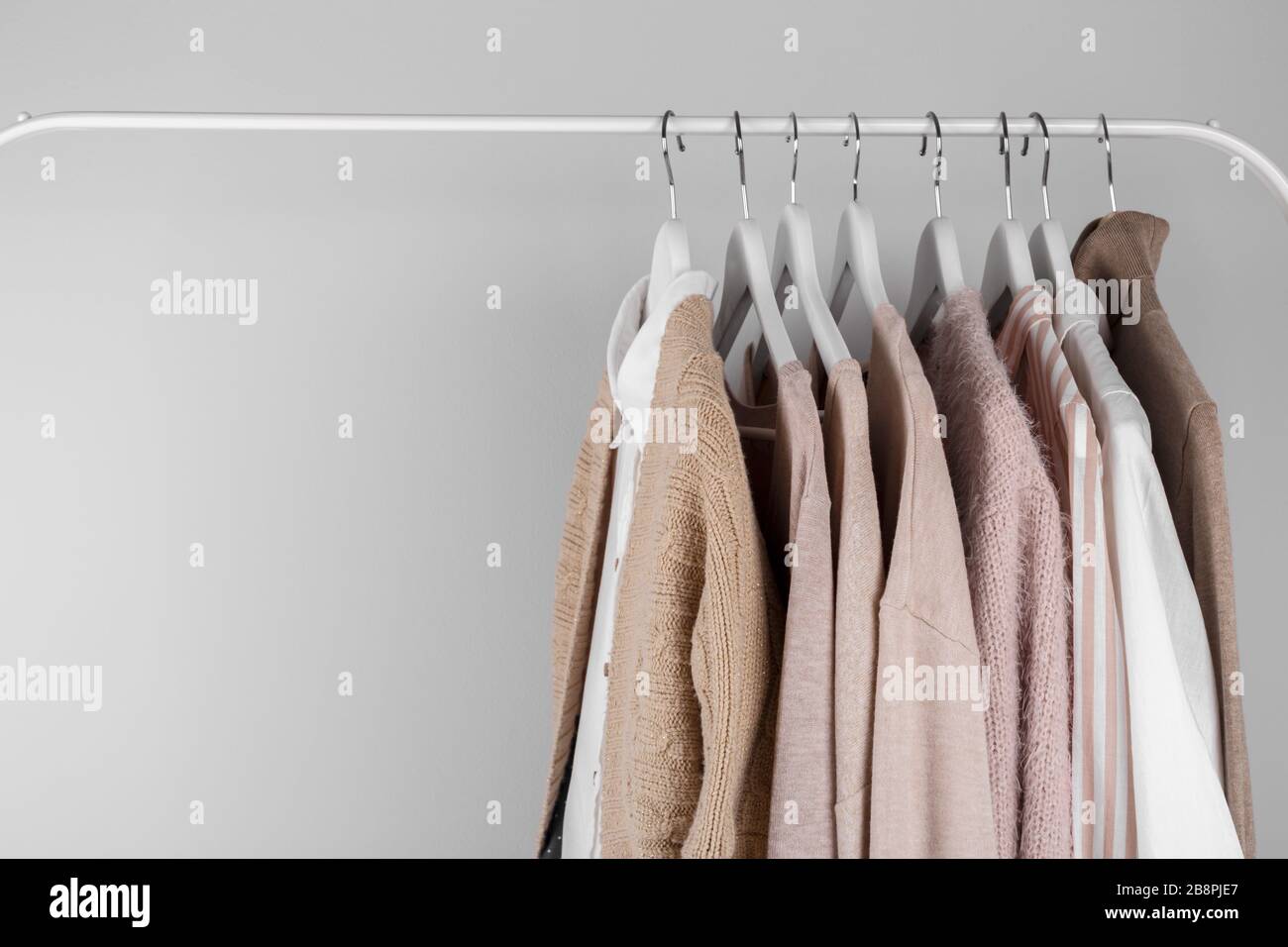Spring female clothes hanging on a rack, trending pastel colors Stock ...