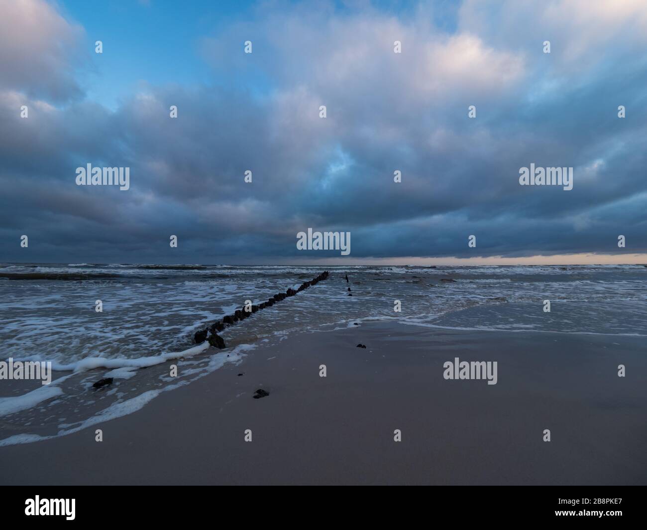 Sunrise at the estuary of the Piasnica River, Poland, Debki. Remains of ...
