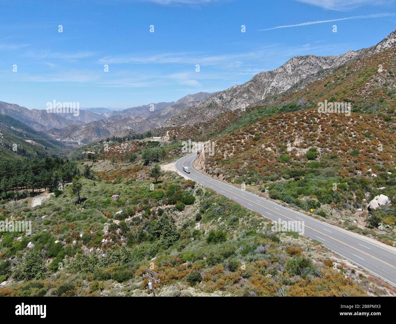 Asphalt road bends through Angeles National forests mountain ...