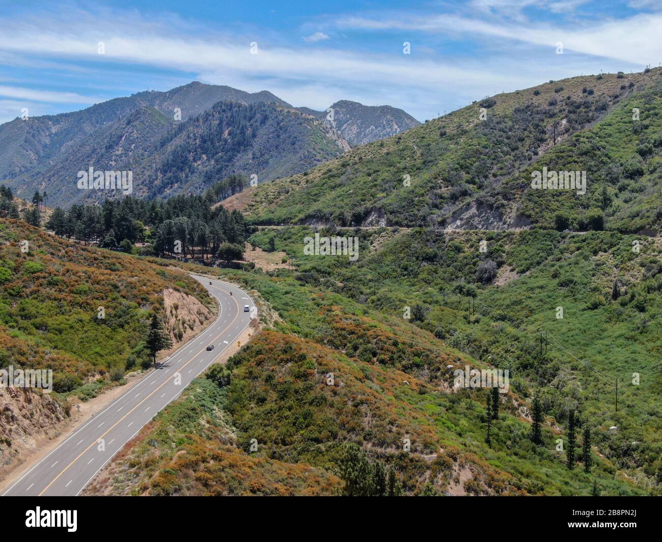 Asphalt road bends through Angeles National forests mountain ...
