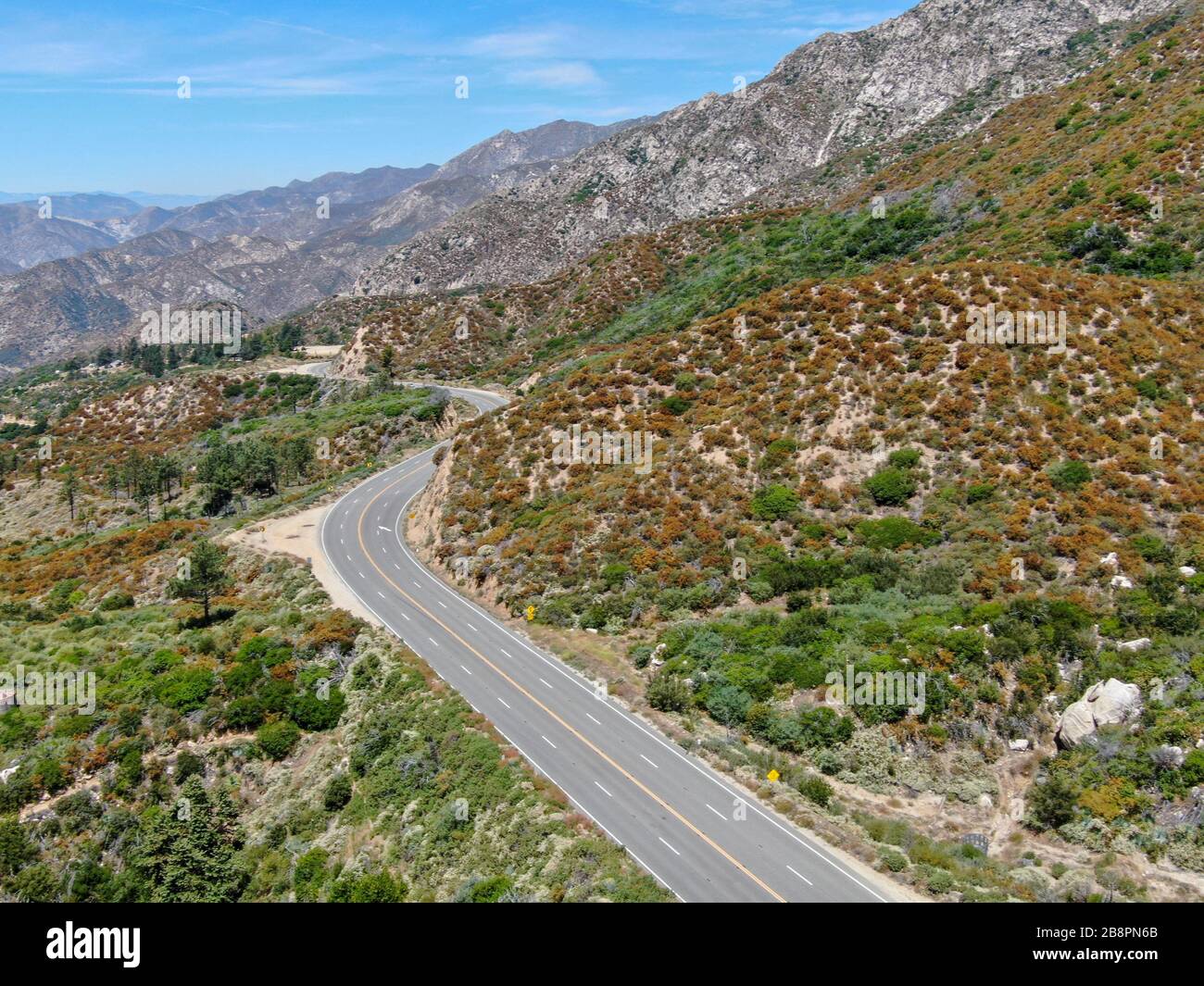 Asphalt road bends through Angeles National forests mountain ...