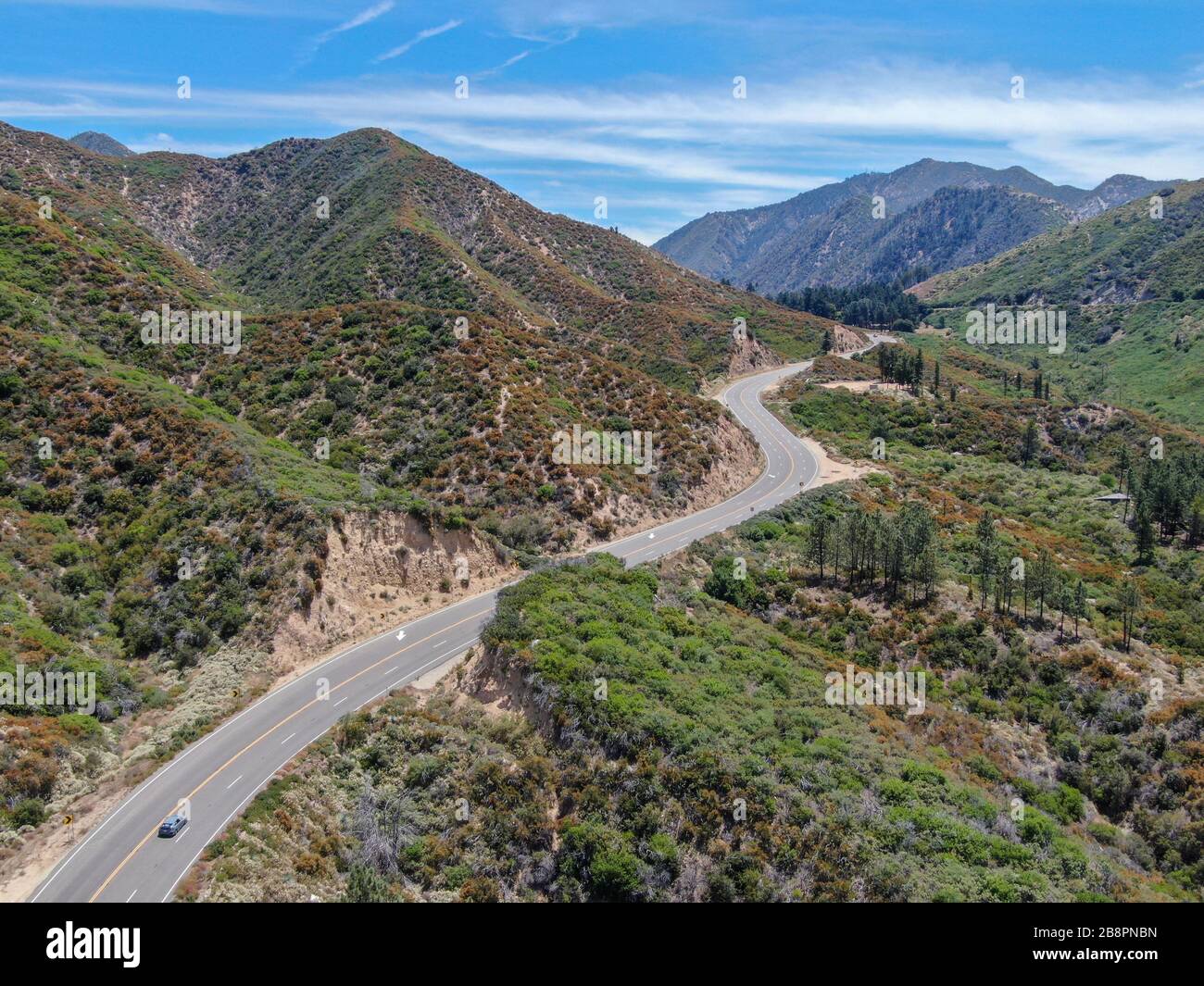 Asphalt road bends through Angeles National forests mountain ...