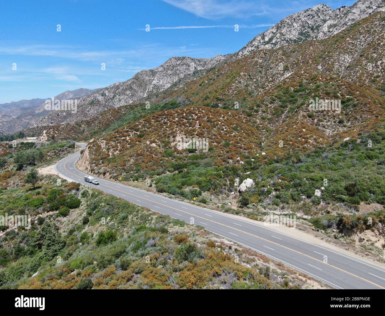 Asphalt road bends through Angeles National forests mountain ...