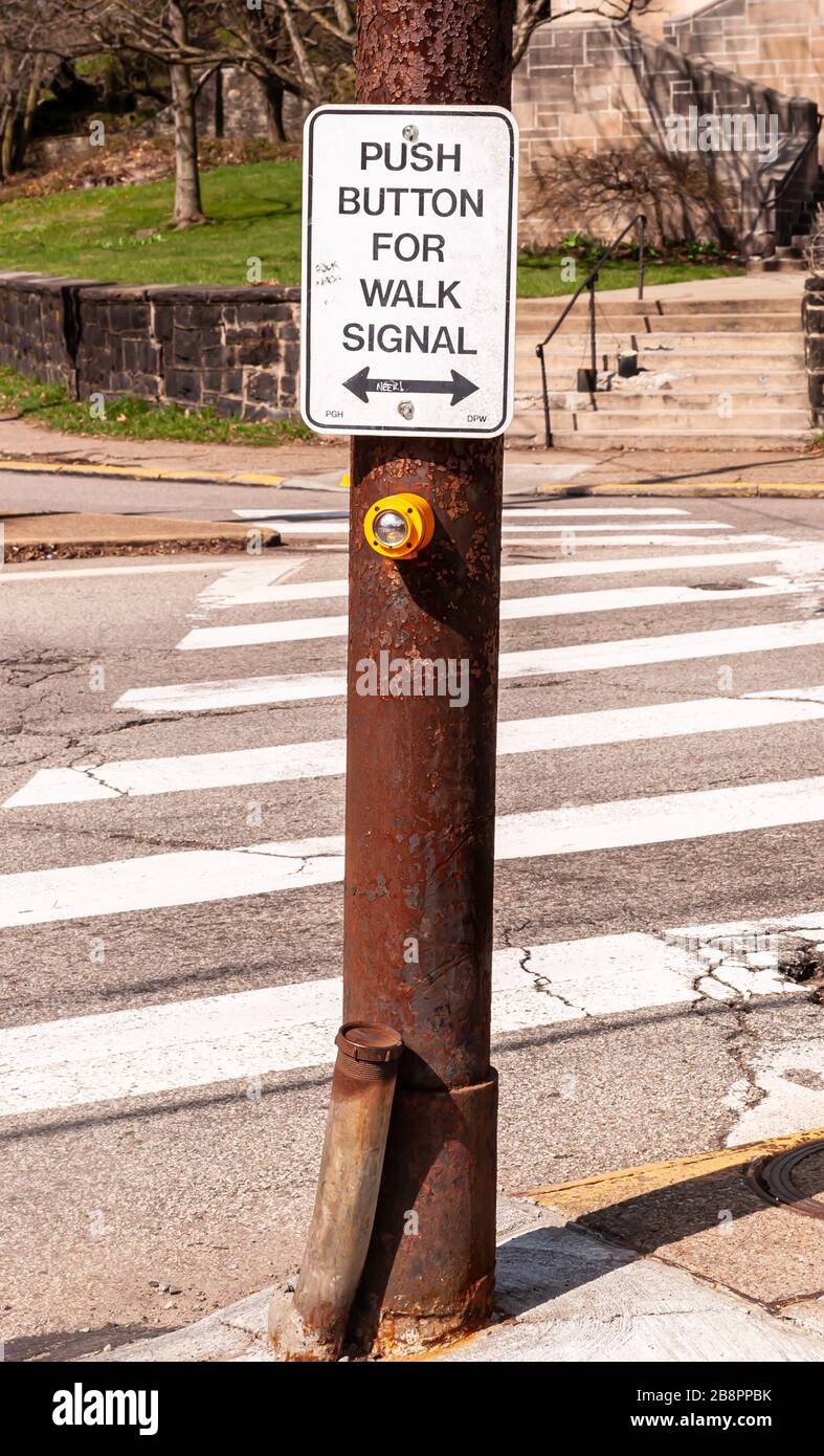 A push button box and sign for a crosswalk with the crosswalk in the ...